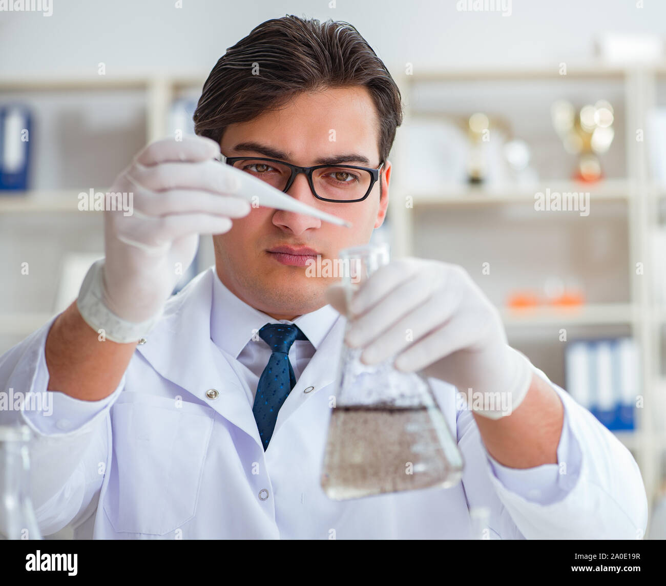 Young researcher scientist doing a water test contamination experiment ...