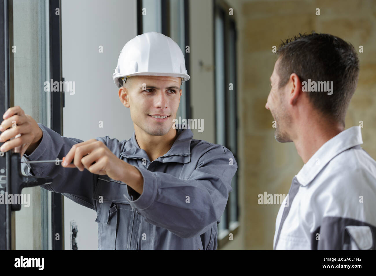 two happy windows installation workers Stock Photo - Alamy