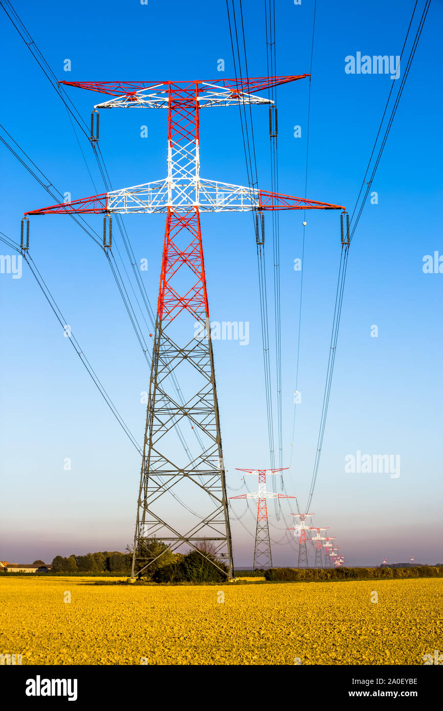 Electricity transmission pylon silhouetted against blue Stock Photo - Alamy