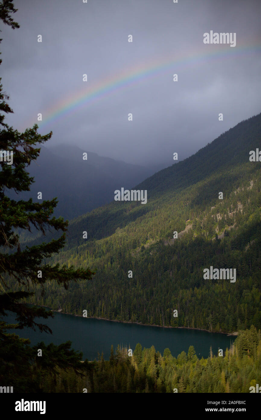 A partial rainbow above the lake and mountains, seen hiking on Goat ...