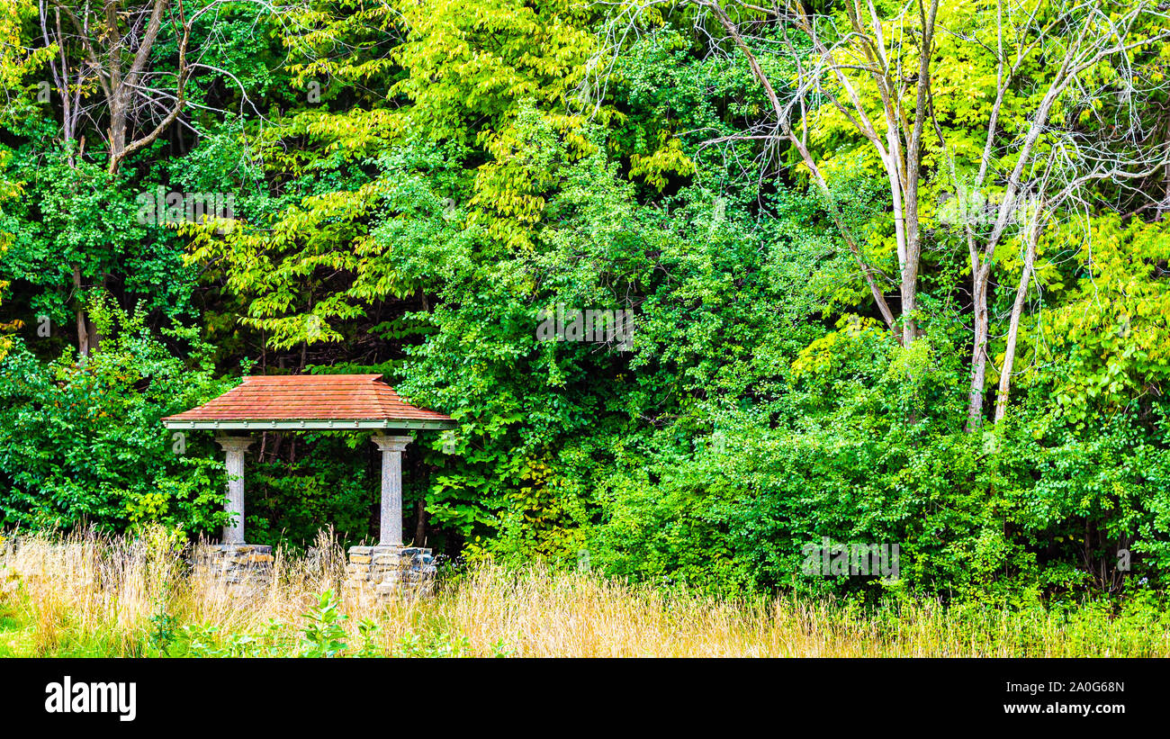 The entrance to a pathway leading into the forest is marked with an ...