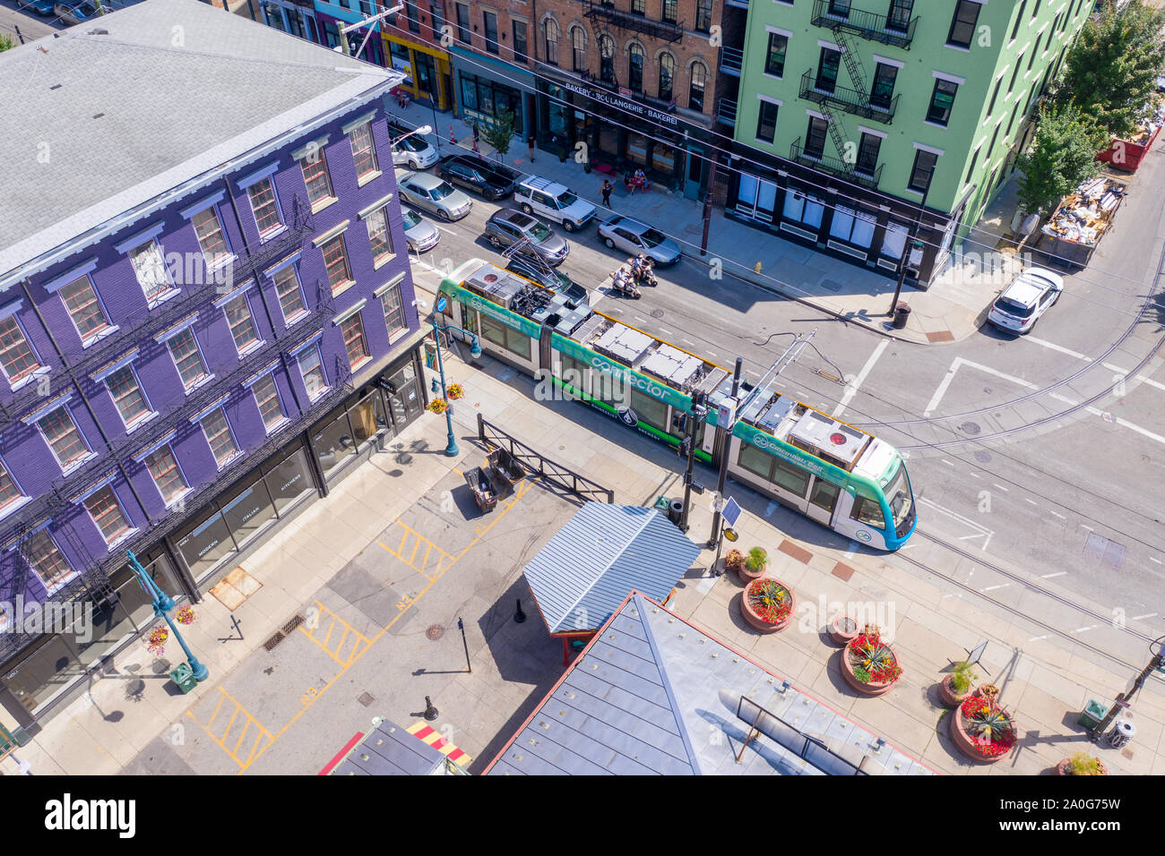 Aerial view of the green tram, light rail, city connector in inner city ...