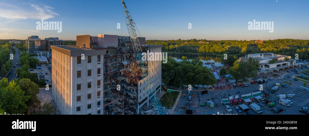 Aerial view of an office building under demolition by a wrecking ball ...