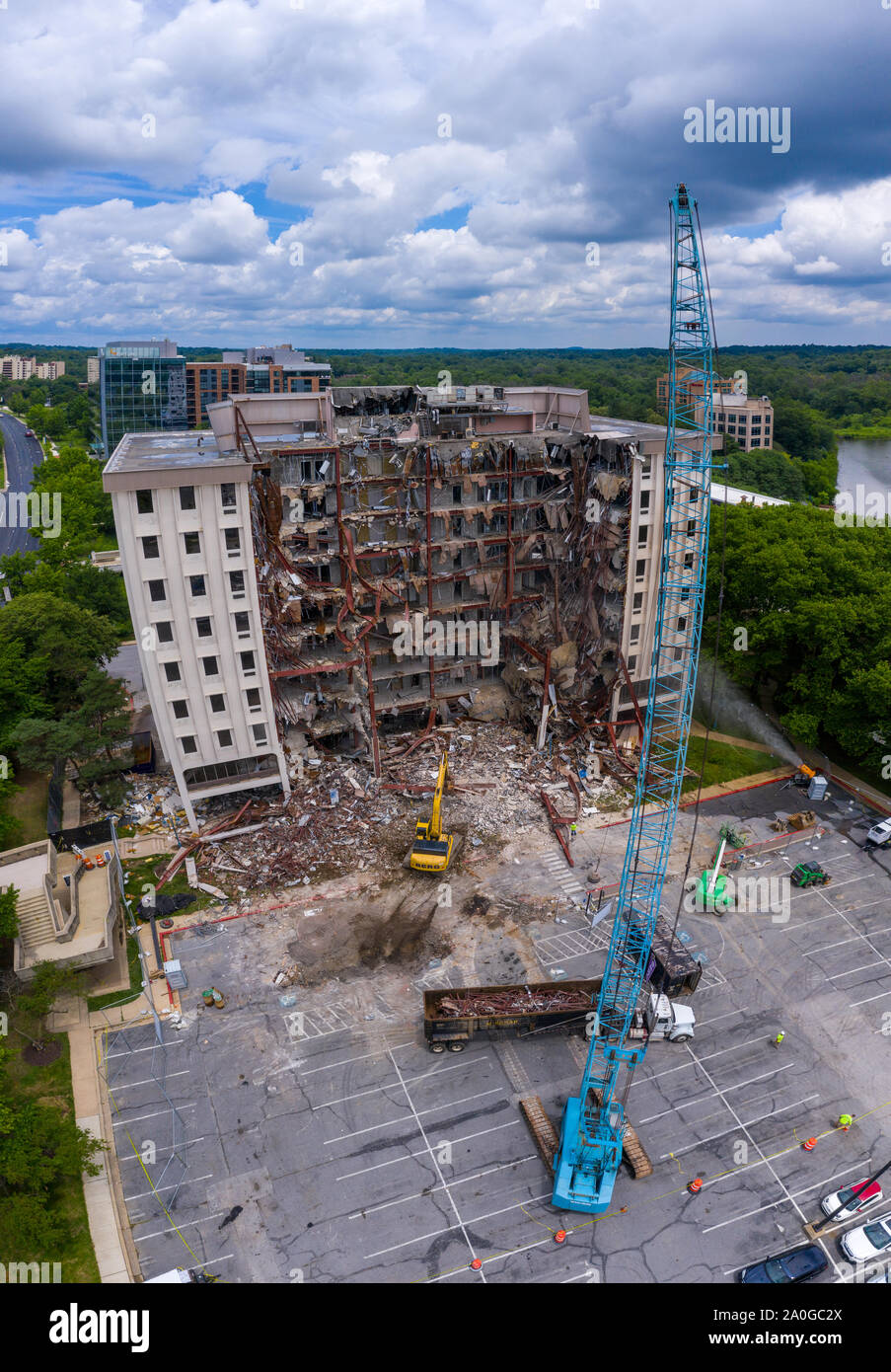 Aerial view of an office building under demolition by a wrecking ball ...