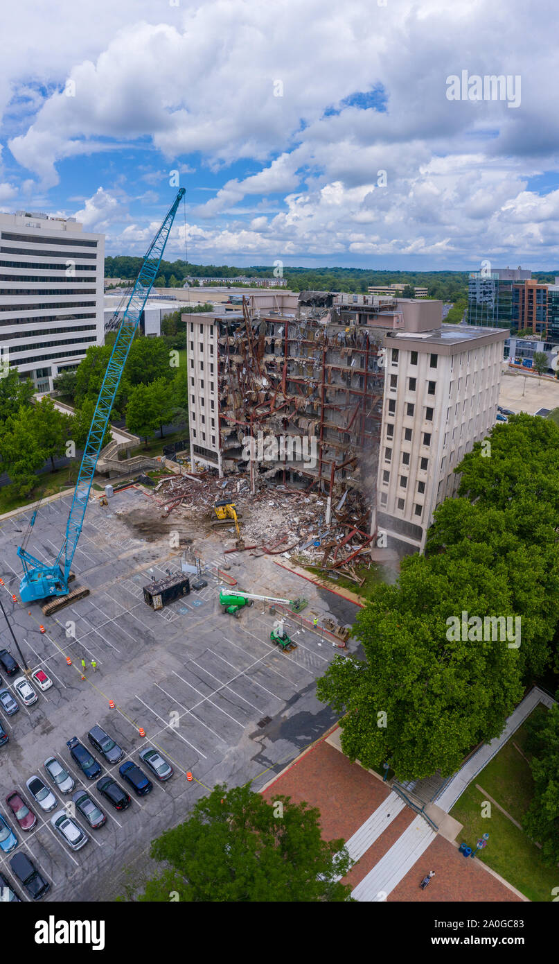 Aerial view of an office building under demolition by a wrecking ball ...