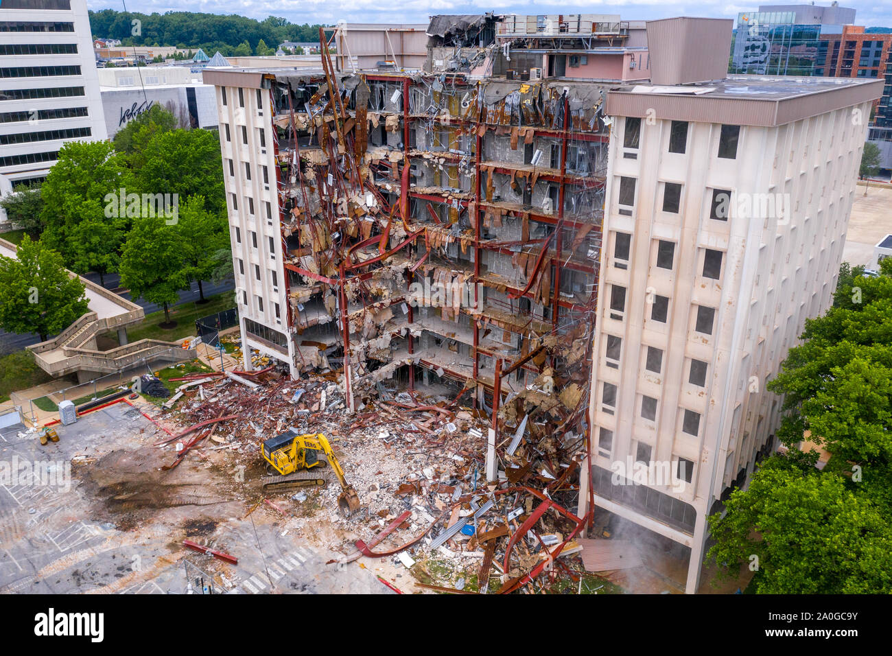 Aerial view of an office building under demolition by a wrecking ball ...