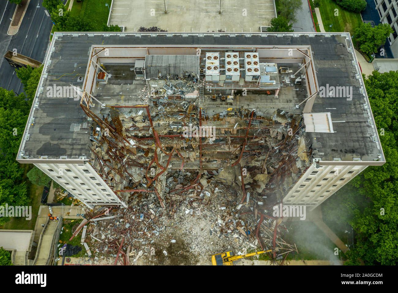 Aerial view of an office building under demolition by a wrecking ball ...