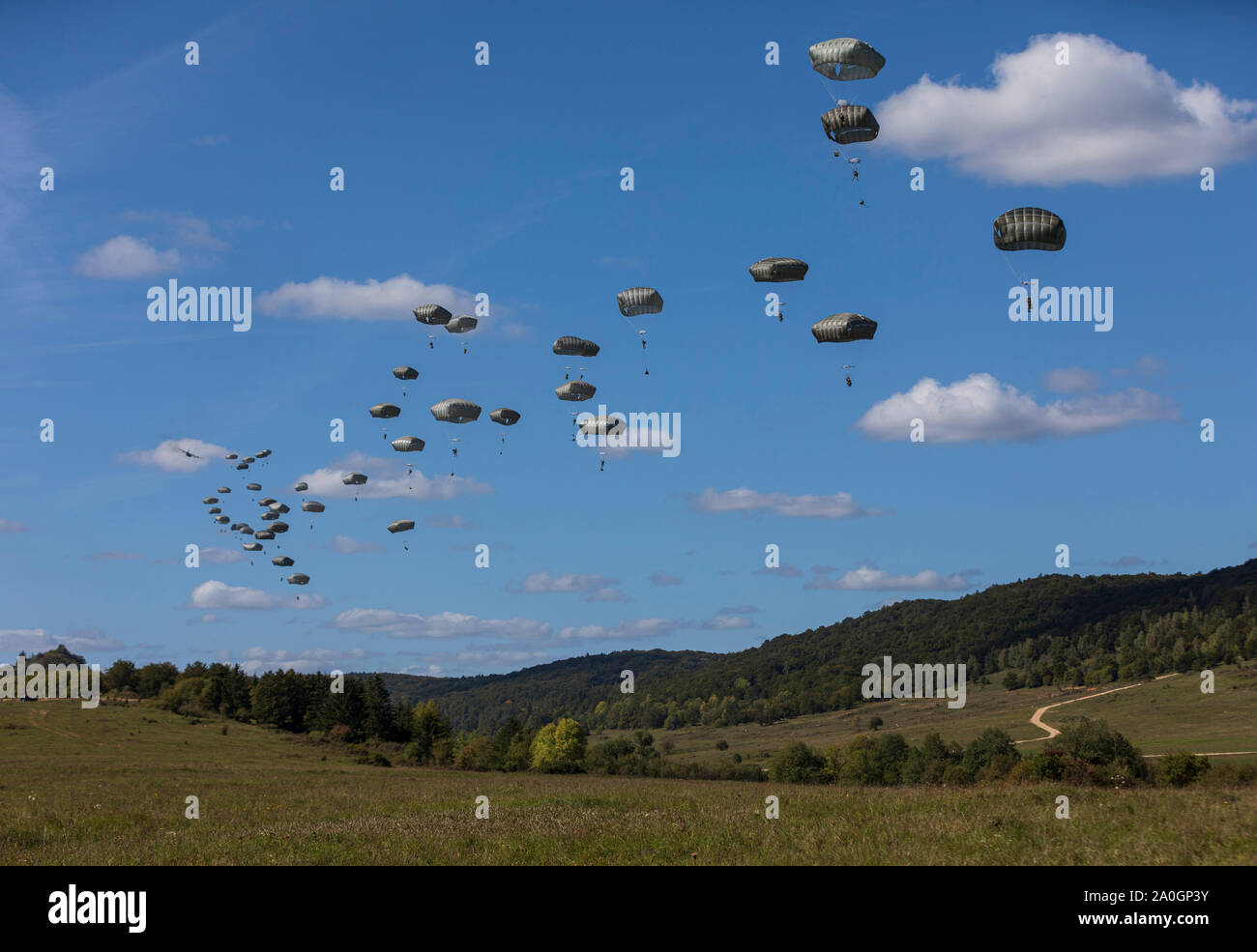 U.S. Army Paratroopers from the 173rd Airborne Brigade jump alongside ...