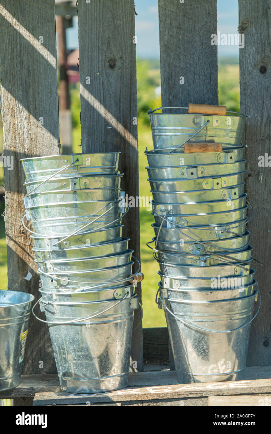 Pile of buckets on farm used for harvesting Stock Photo - Alamy