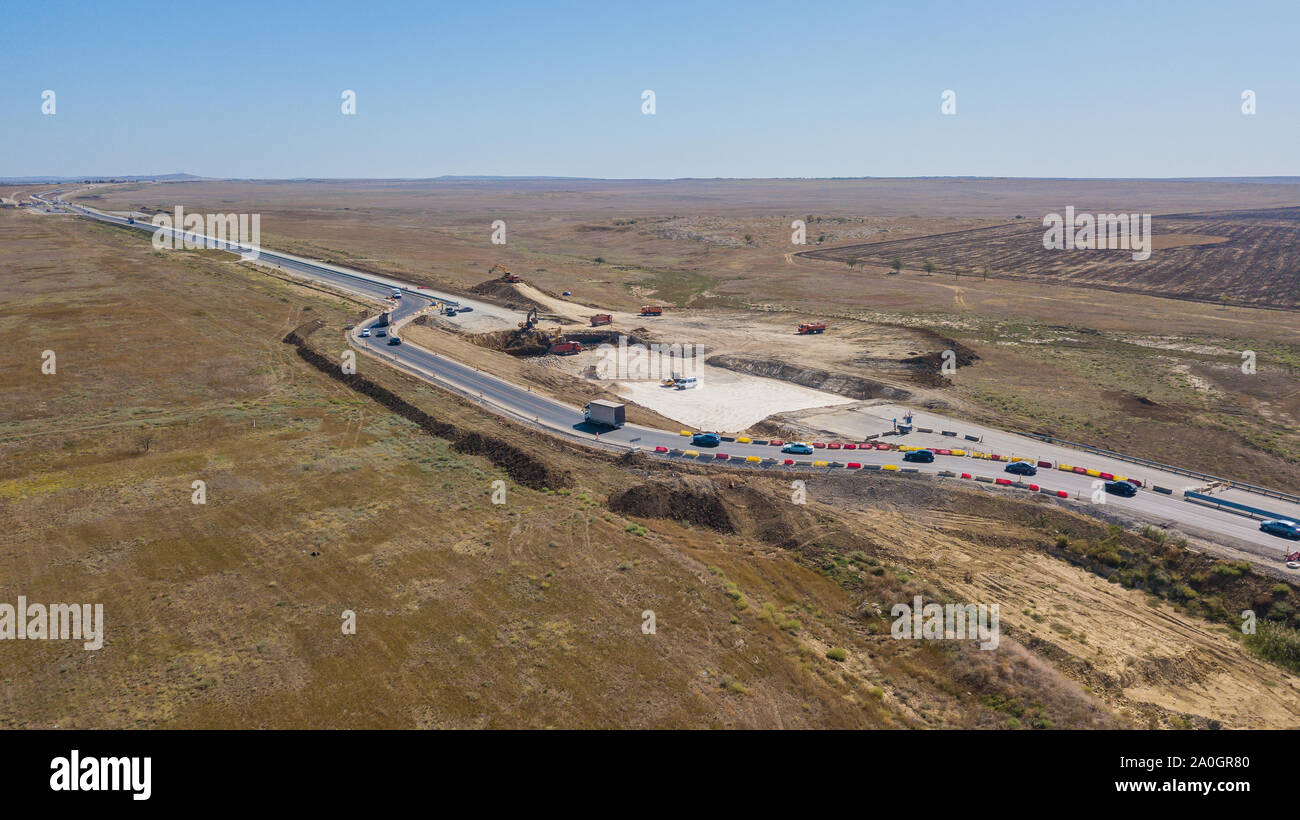 Drone fly over the road on which the cars are traveling, and the ...