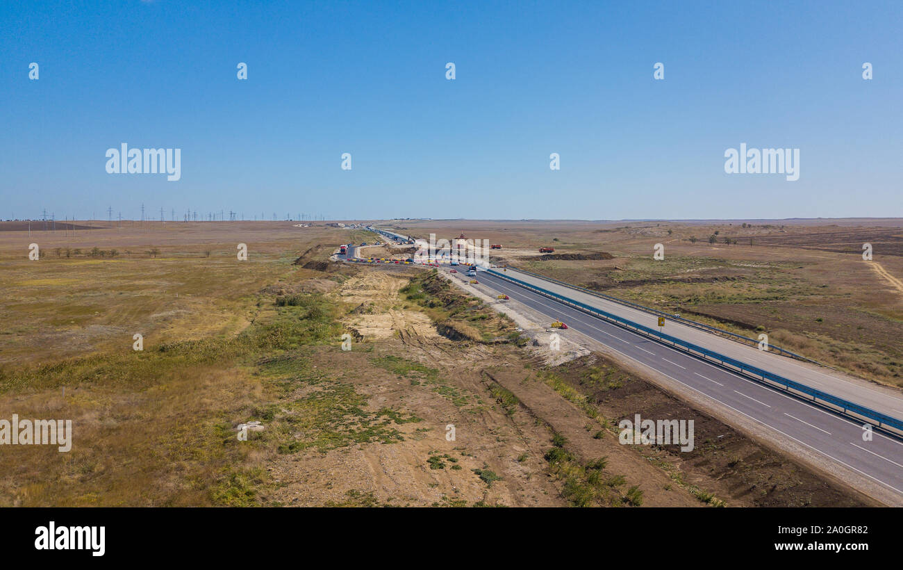 Drone fly over the road on which the cars are traveling, and the ...