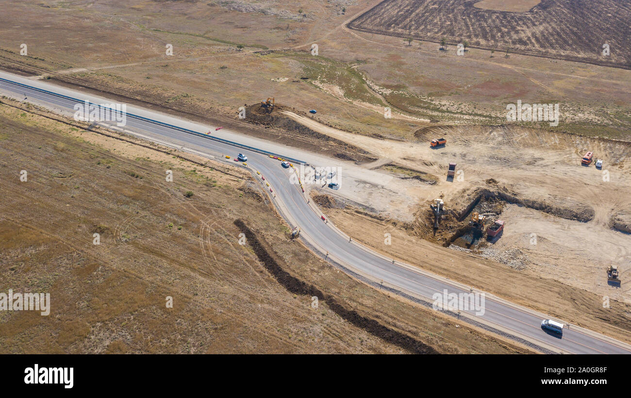 Drone fly over the road on which the cars are traveling, and the ...