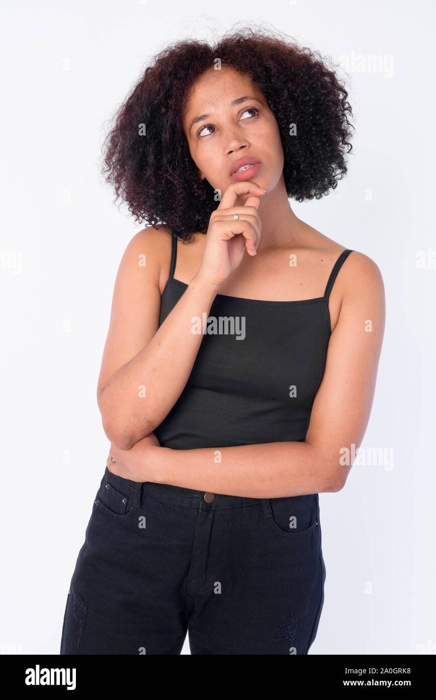 Portrait of young beautiful African woman thinking and looking up Stock ...