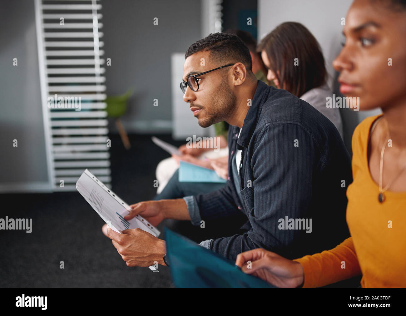 Side view of a confident young african american man wearing eyeglasses ...