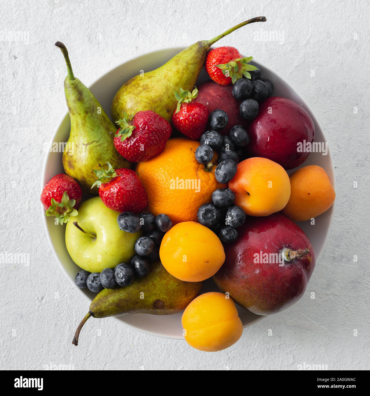 Mix fruits plate on a light background top view Stock Photo - Alamy