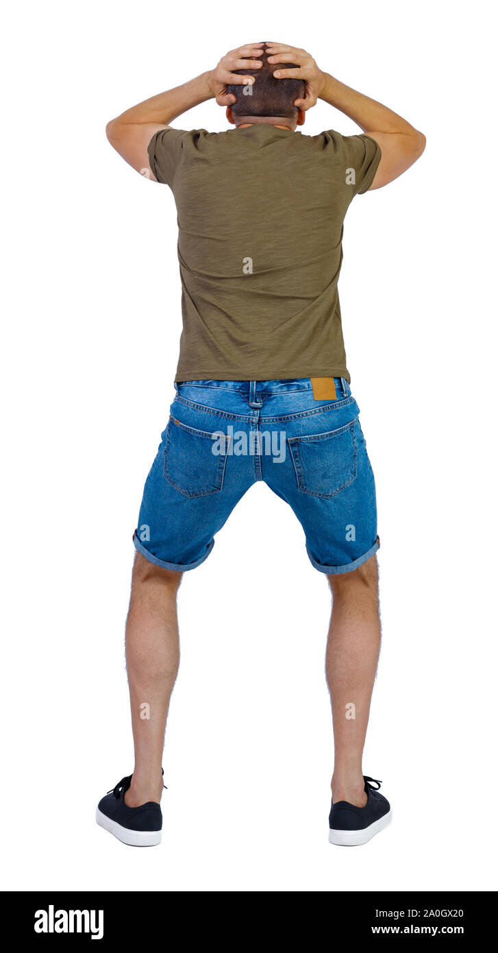 Back view of angry young man in shorts. Rear view. isolated over white ...
