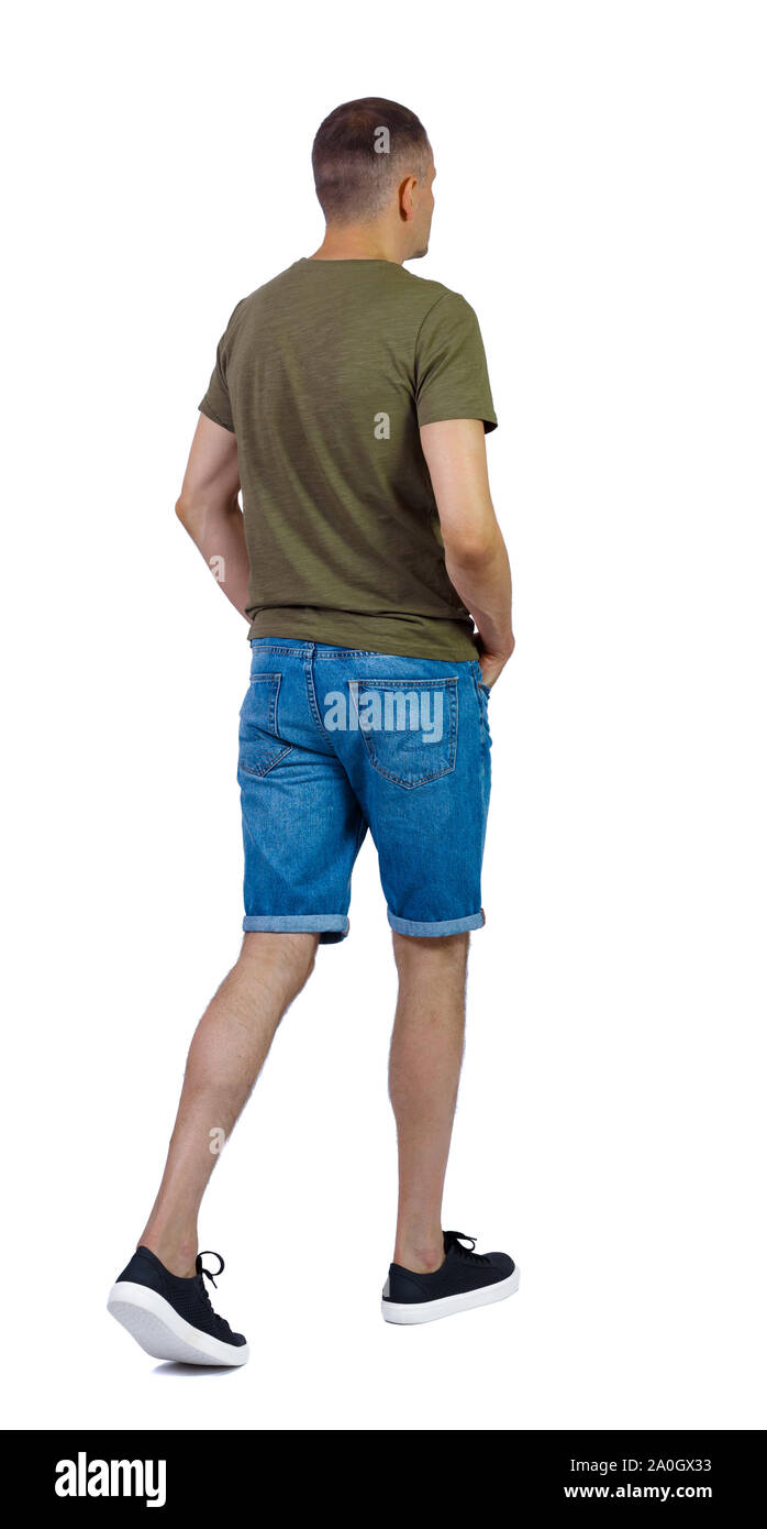 Back view of going handsome man in shorts. walking young guy . Rear ...