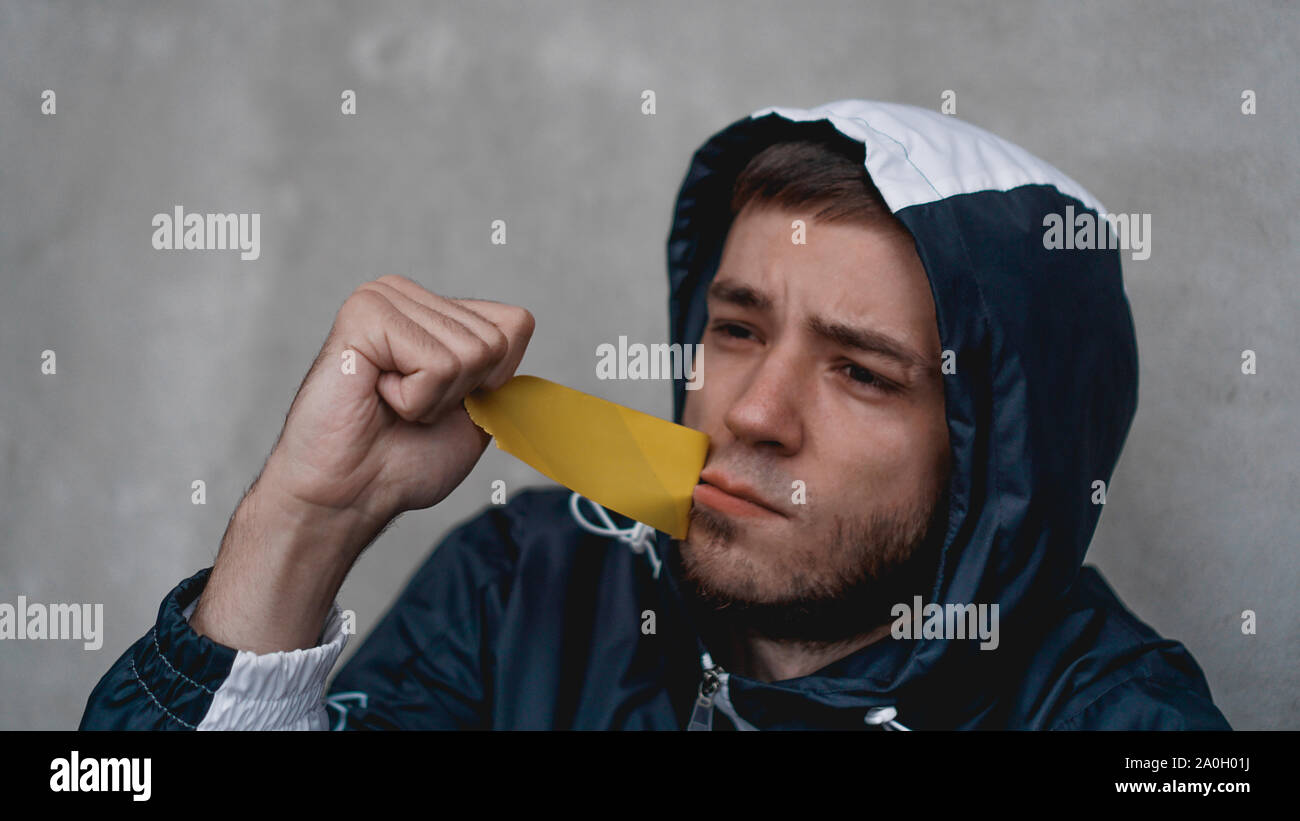 Man with tape over his mouth. The mouth is sealed with warning tape ...