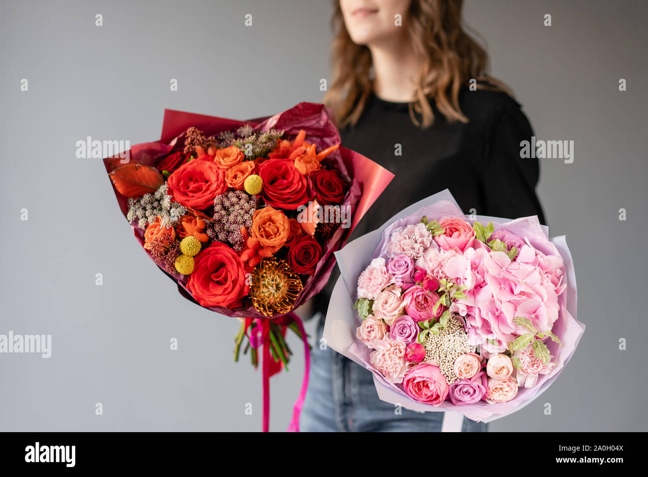 Two Beautiful bouquets of mixed flowers in womans hands. the work of ...