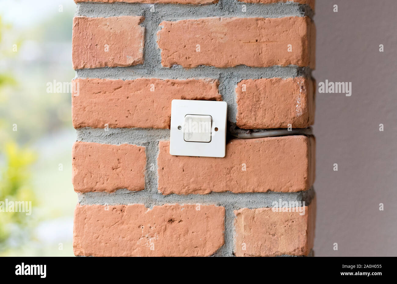 Lightswitch in a brick wall, building on Madagascar Stock Photo - Alamy
