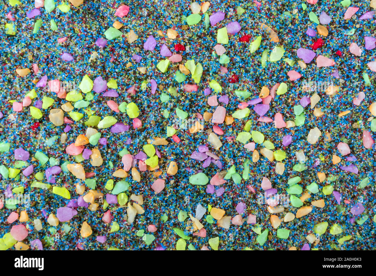 Top view with background of multi-colored small pebbles. Multi-colored ...