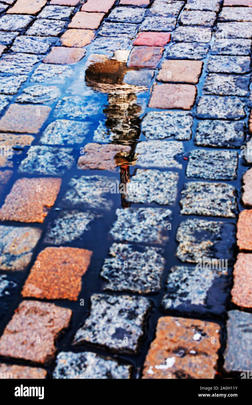 Reflection building in a puddle , road water, raining drops, rain drops ...