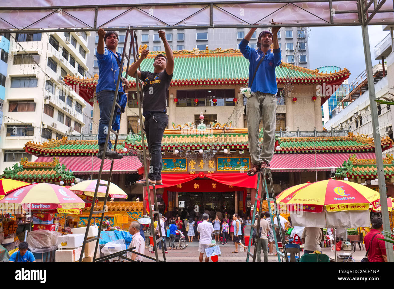 Workers opposite Kwan Im Thong Hood Cho Temple in, a much visited ...