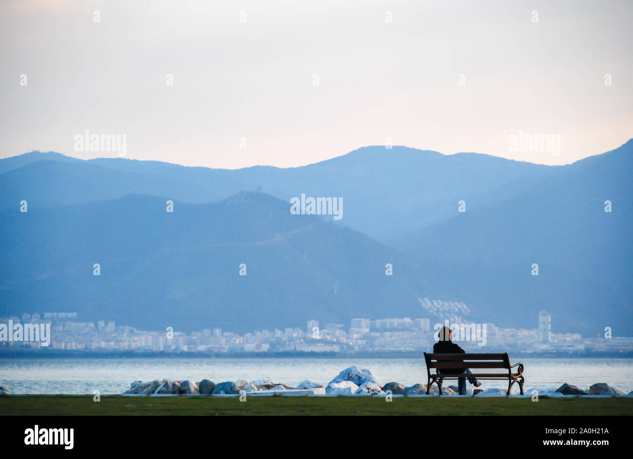 A Woman Sitting on the Bench near seaside, Watching Sea and enjoying ...