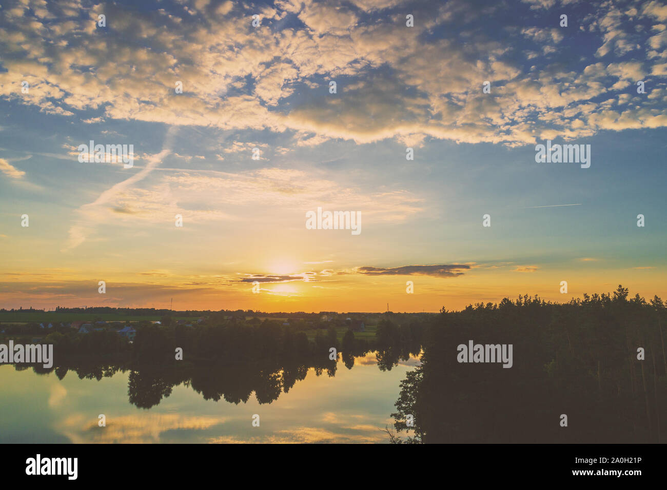 Magical sunrise over lake with a beautiful reflection on the water ...