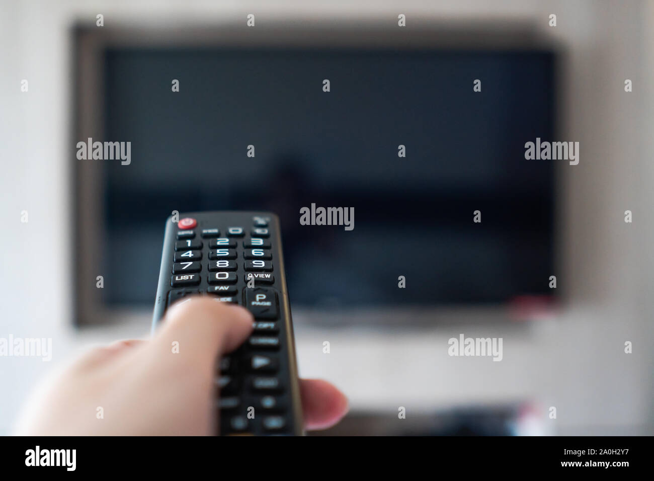 hand holding remote control point to television Stock Photo - Alamy