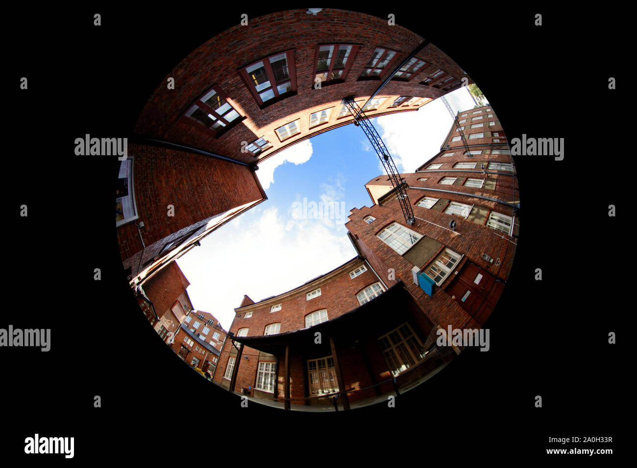 A fish eye image of an old factory building with blue sky above Stock ...