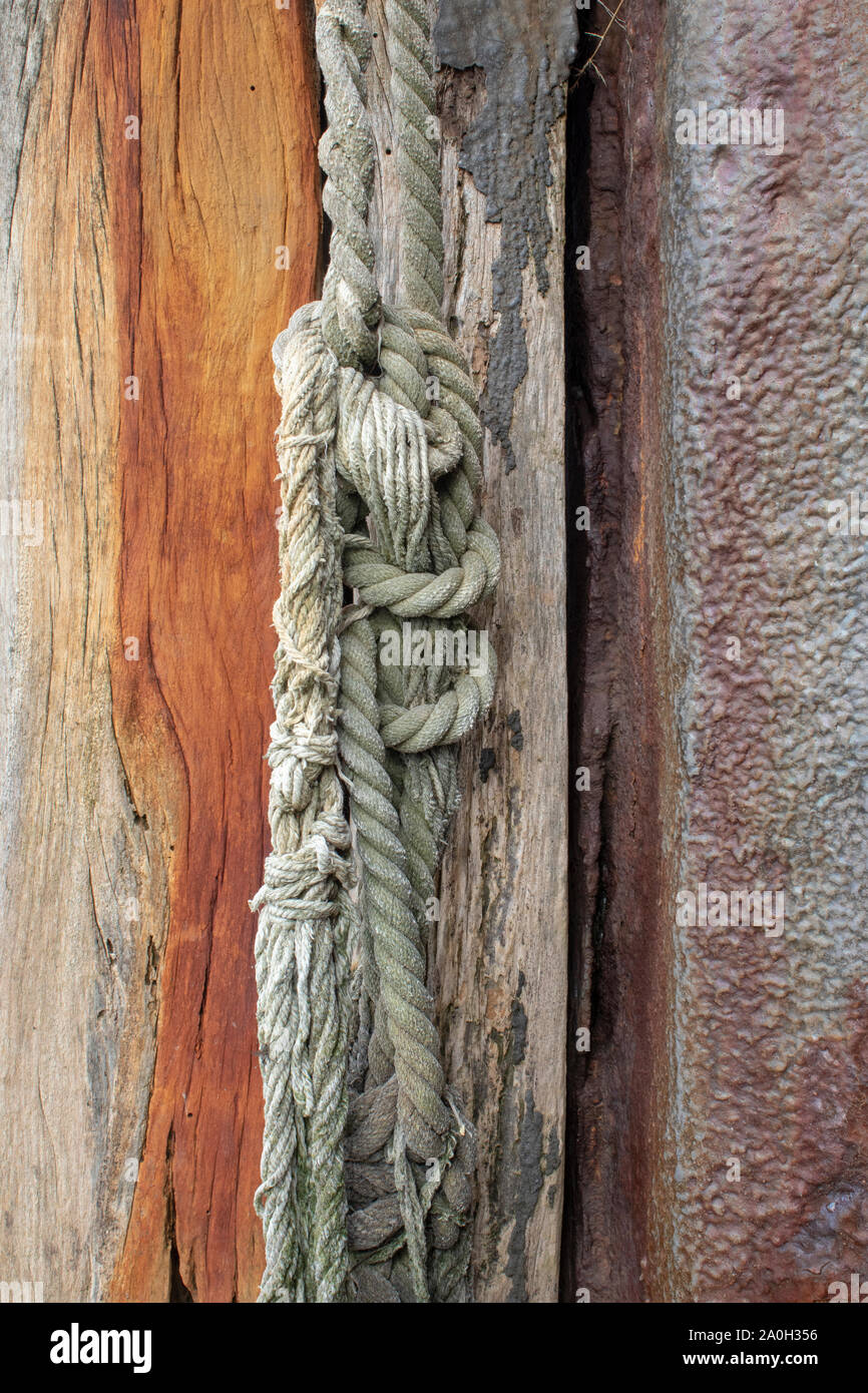 Old nautical rope hanging from a weathered wooden post at Old Leigh ...