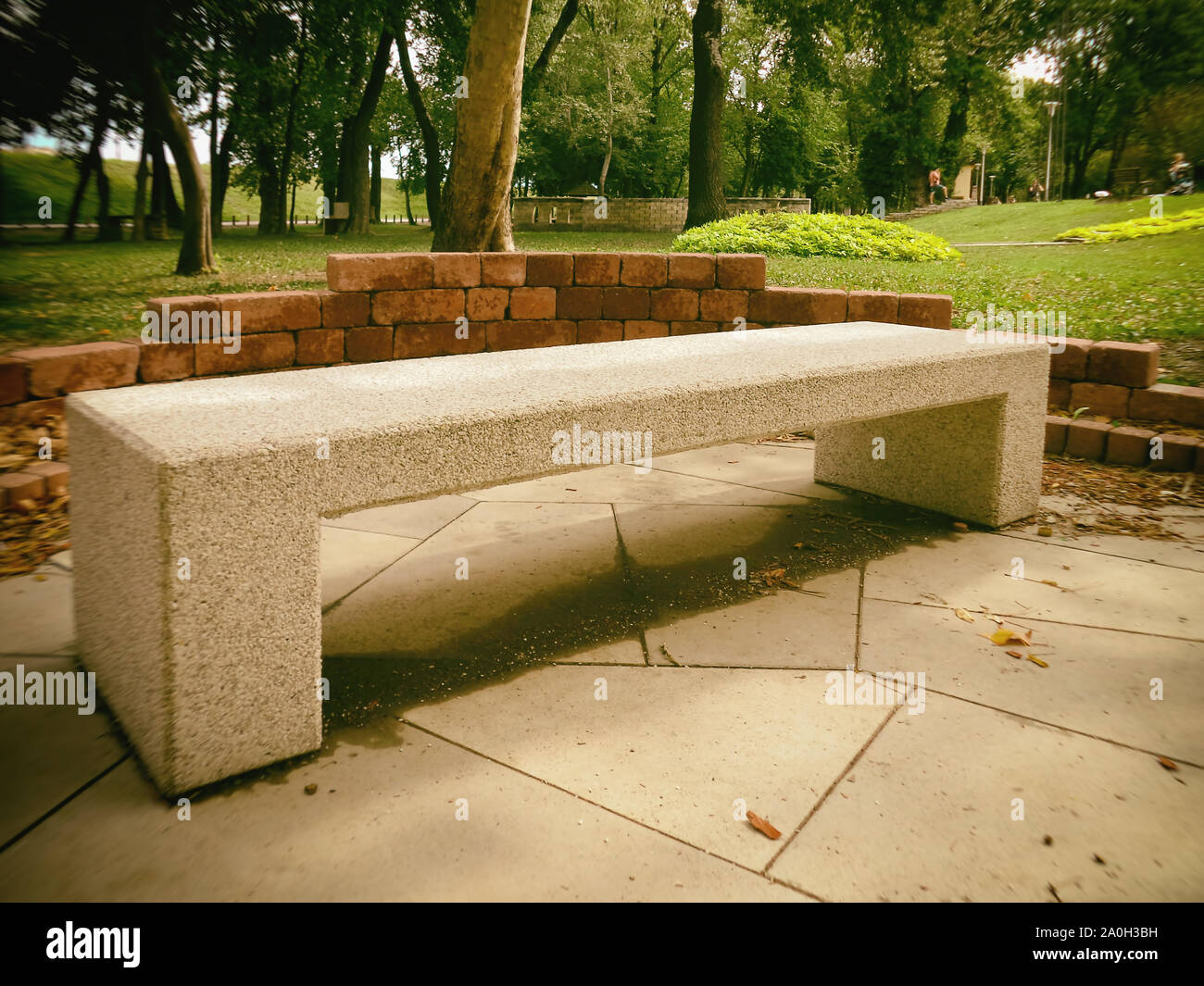 An old concrete bench in the park, background, texture, blurred image ...