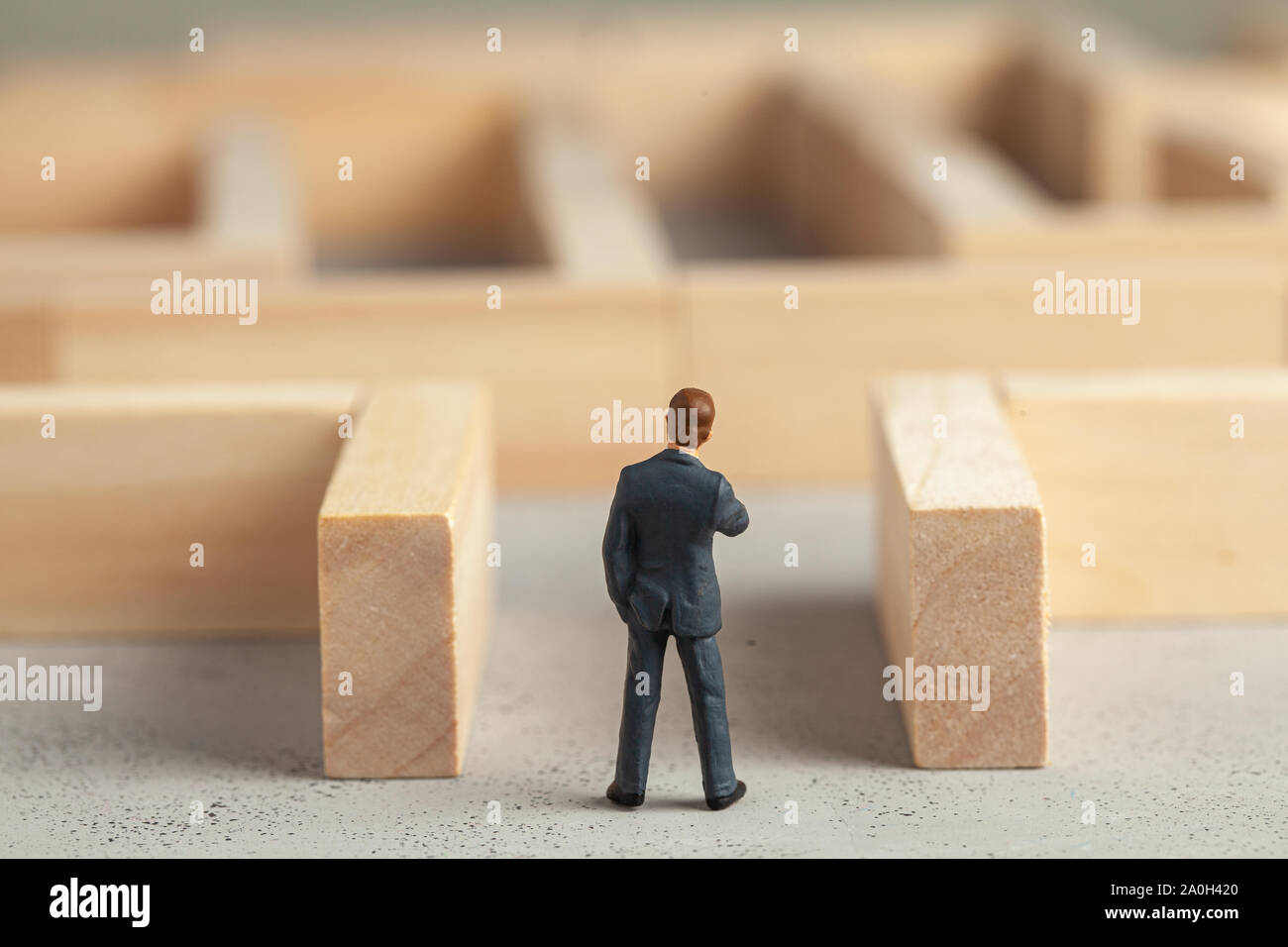 Businessman in the maze as a symbol of solving problems and finding a ...