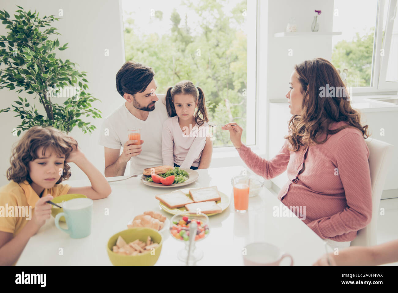 Nice adorable lovely adoptive family, brother and sister, having dinner ...
