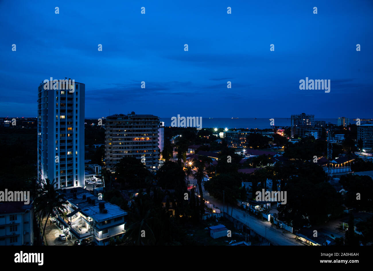night panorama with blue skies of high rise towers and ocean views ...