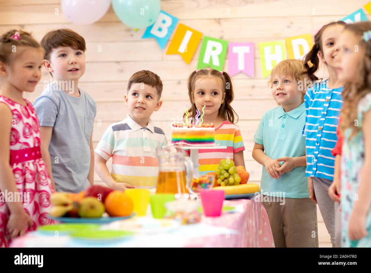 Children celebrating birthday party. Group of preschool kids stand ...
