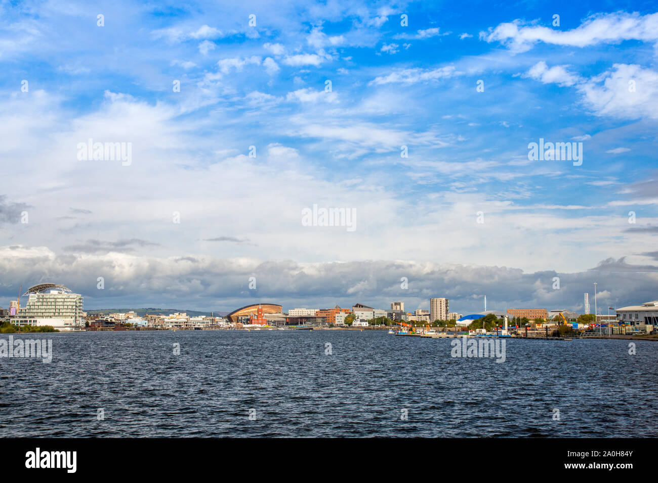 A shaft of sunlight lights up the Millennium Centre and red brick ...
