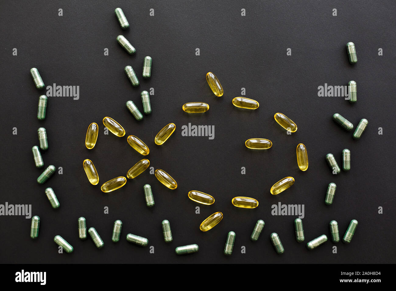 Dietary supplements. Omega 3 capsules in fish shape and spirulina pills ...