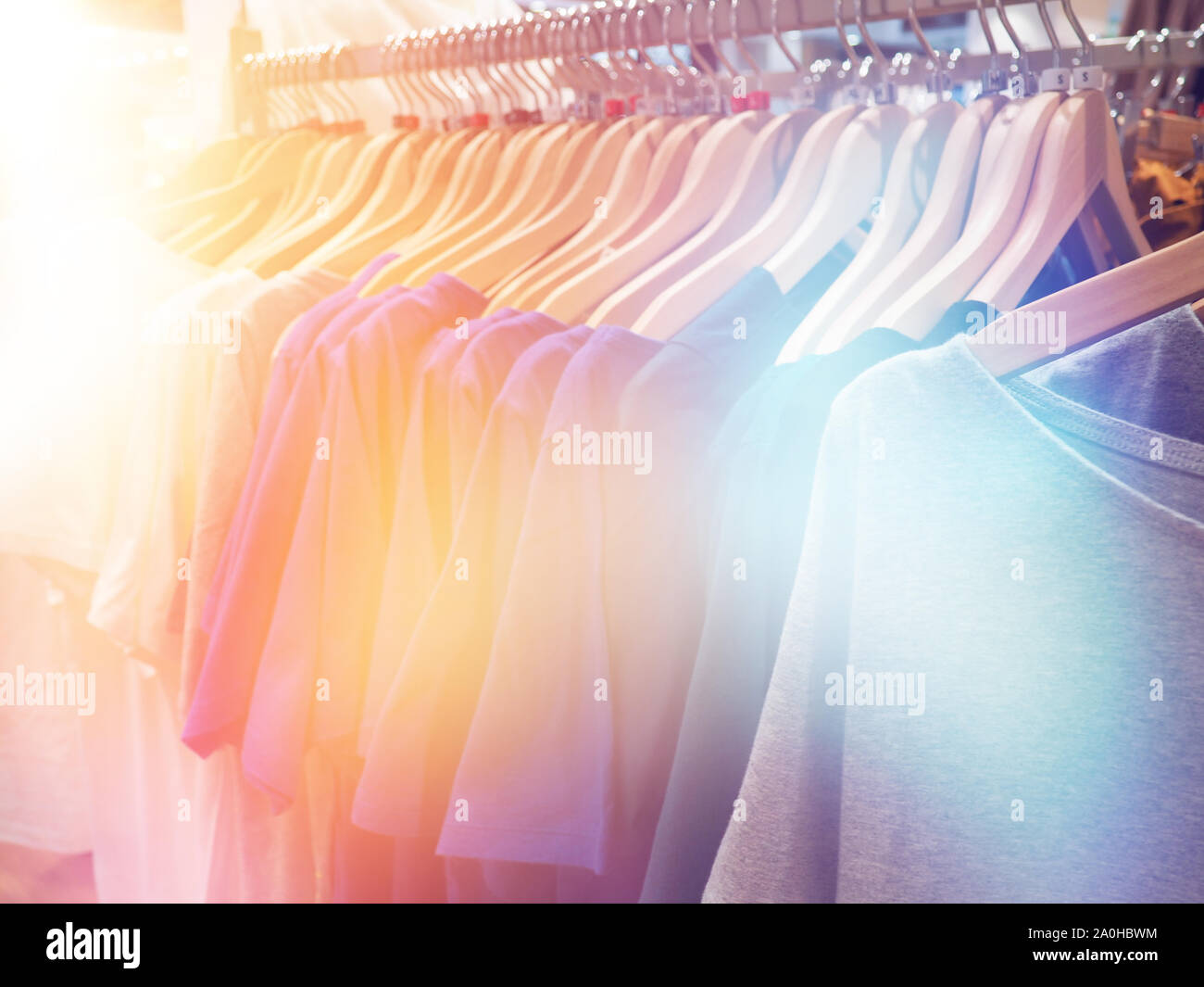 colored clothes on hangers, blurry, flare Stock Photo - Alamy