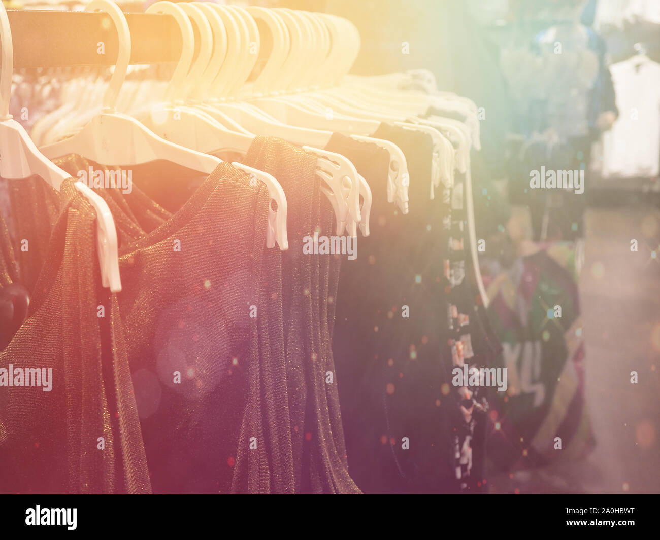 colored clothes on hangers, blurry, flare Stock Photo - Alamy