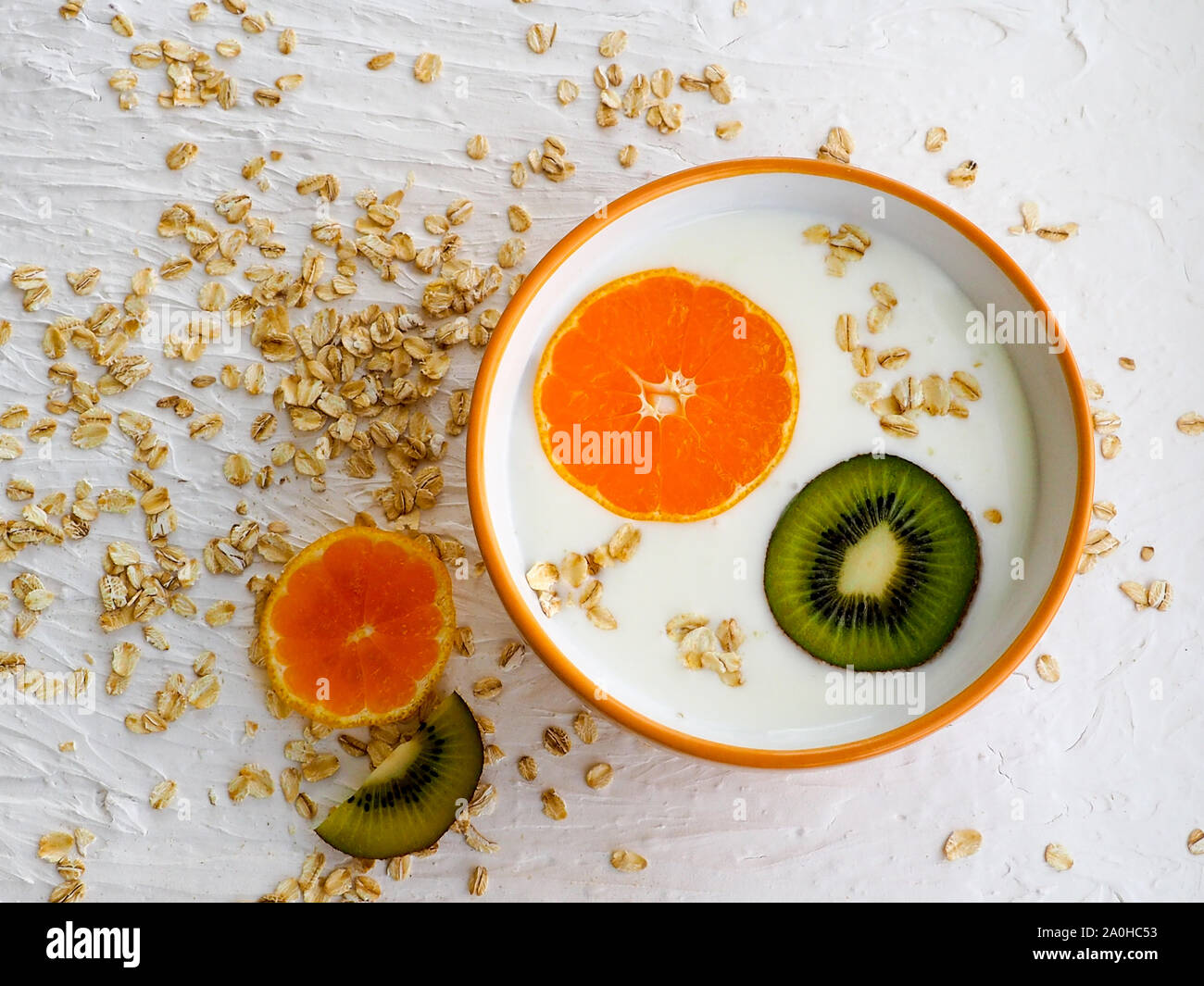 Oatmeal porridge on milk with Mandarin and kiwi Stock Photo - Alamy