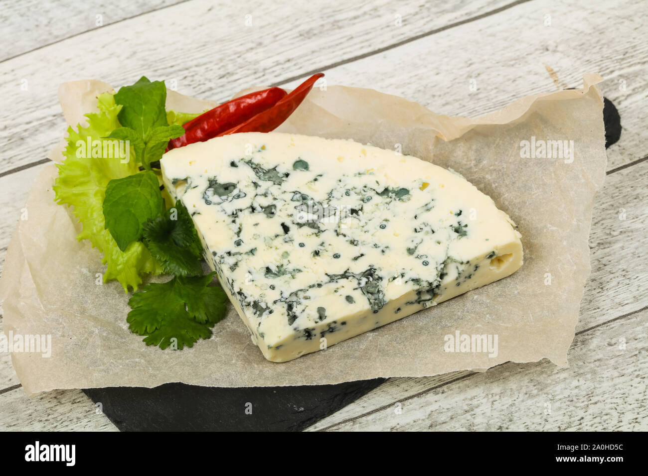 Blue cheese slice with salad leaves Stock Photo - Alamy