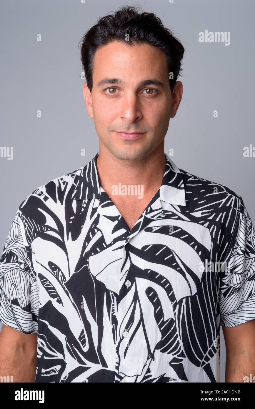 Face of handsome Hispanic tourist man looking at camera Stock Photo - Alamy