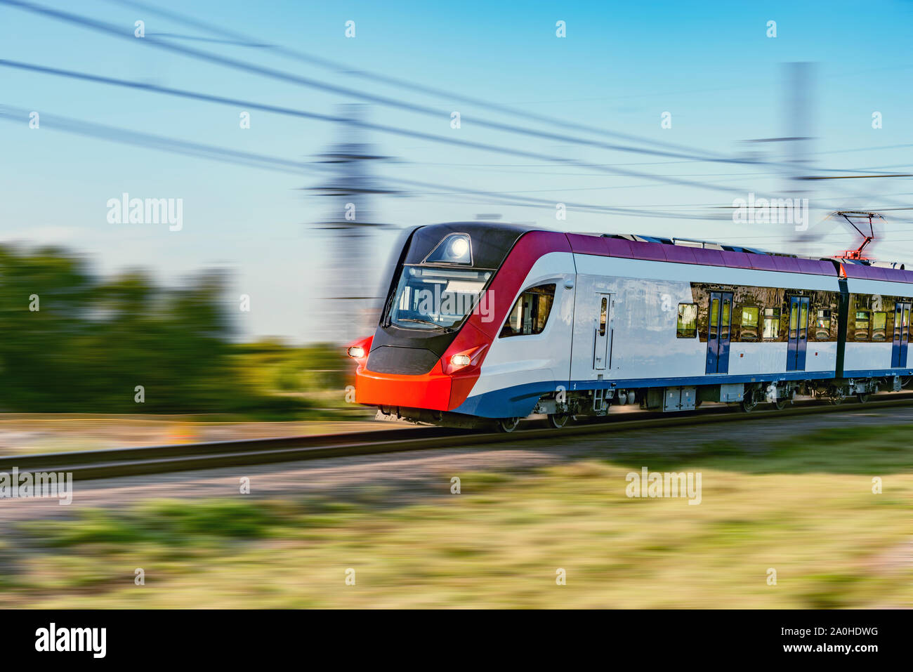 Modern high-speed train moves fast sunny day time Stock Photo - Alamy