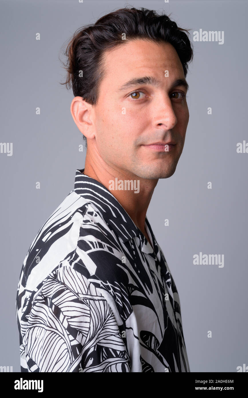 Closeup profile view of handsome Hispanic tourist man looking over ...