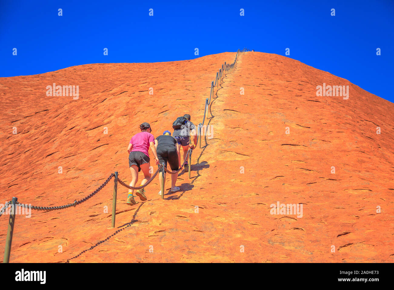 Uluru, Northern Territory, Australia - Aug 23, 2019: Climbers ascend ...