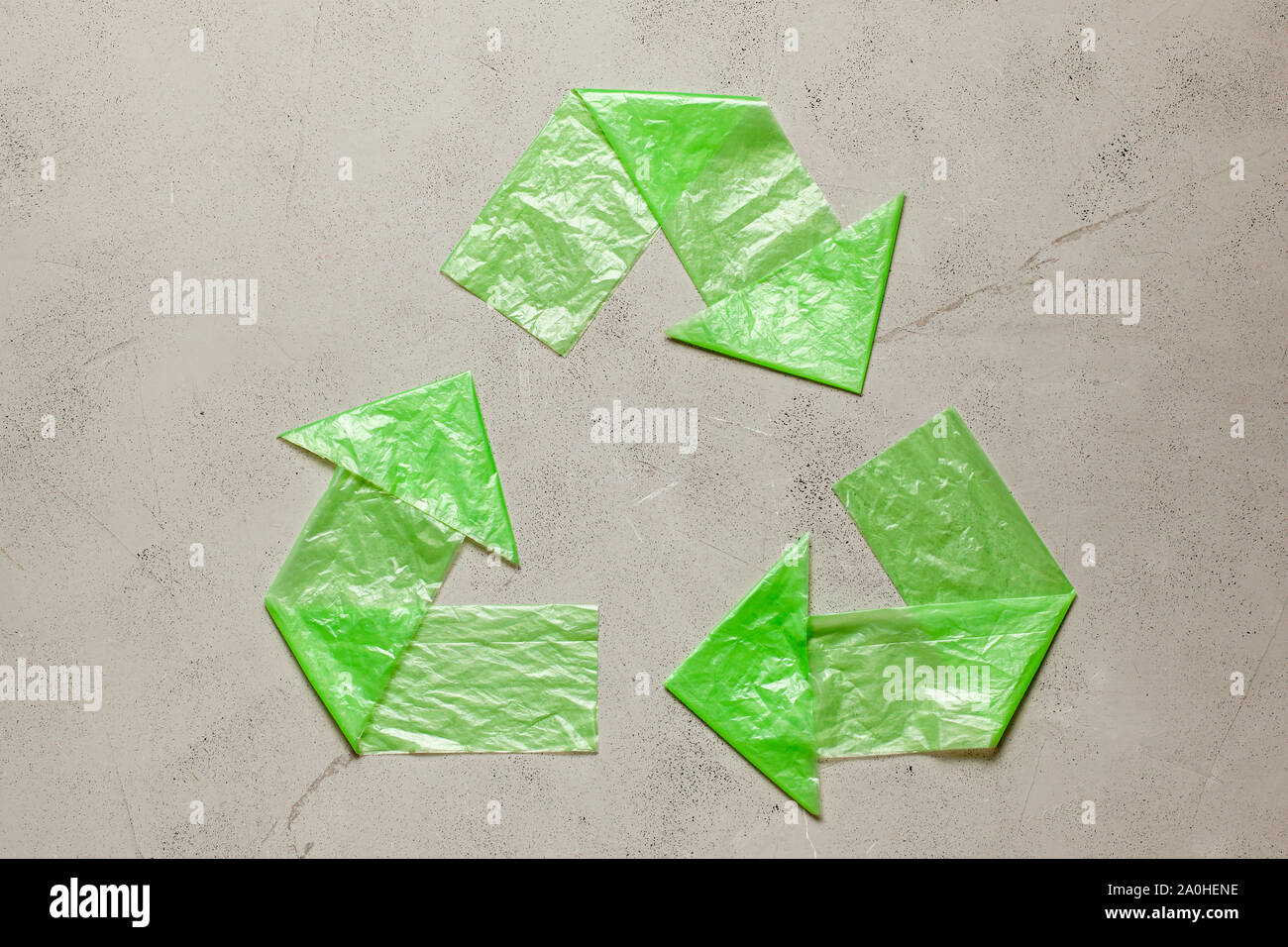 Sign recycling plastic from green bags on gray background ...