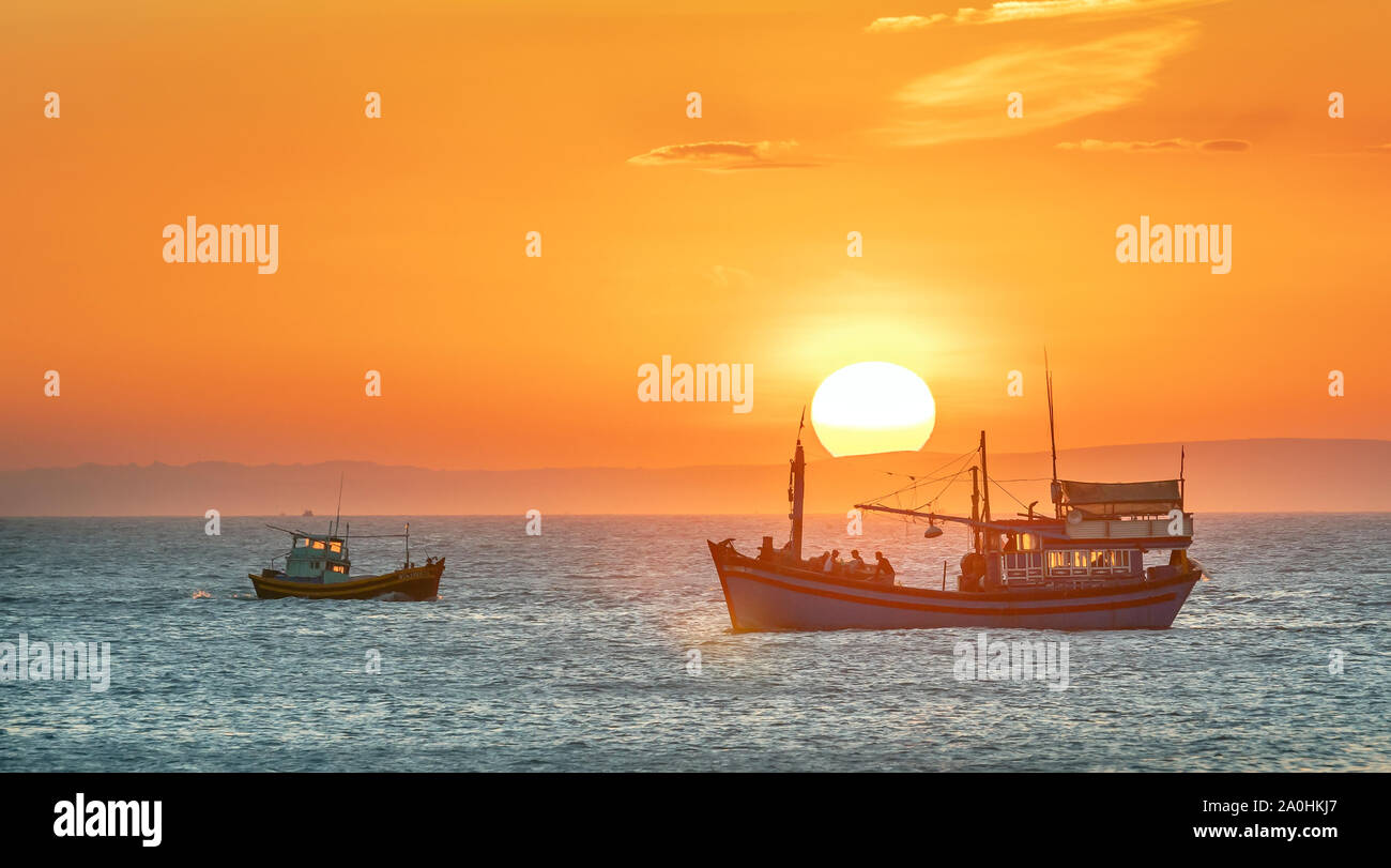 Sea landscape at sunset when fishing boats out to sea to harvest fish ...
