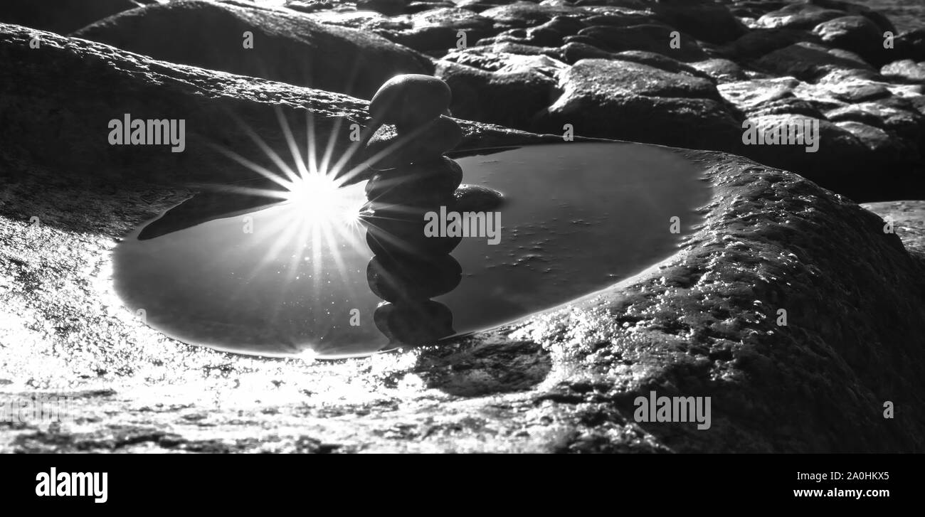 Stacked Pebbles art on mossy rocks welcomes beautiful new day Stock ...